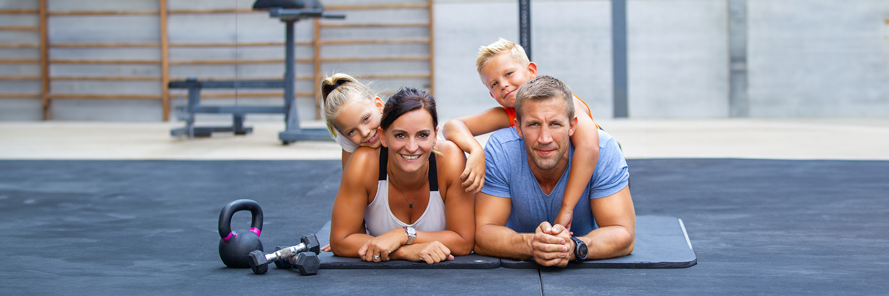 Family Exercising Together In A Gym